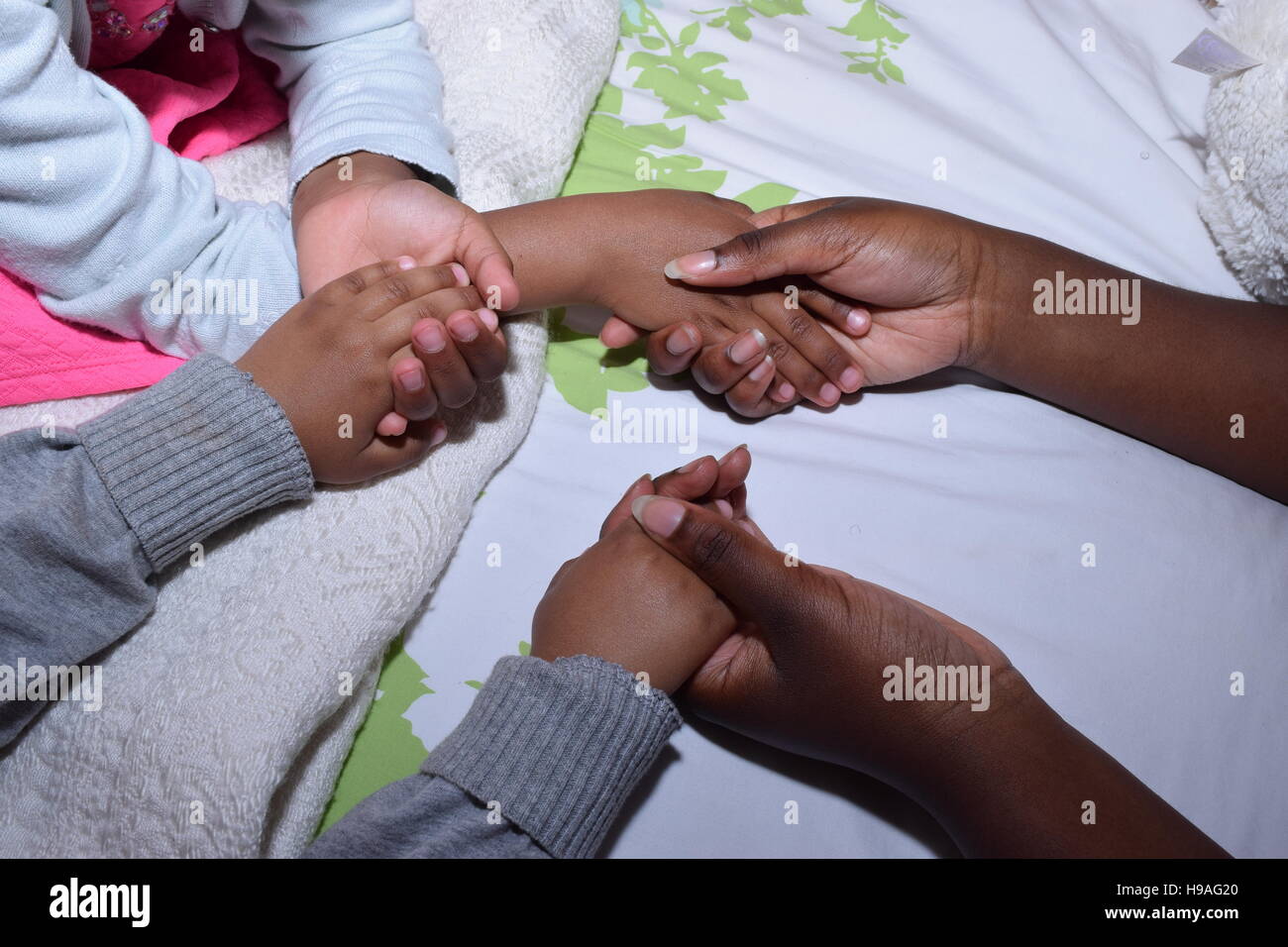Young siblings linking hands Stock Photo - Alamy