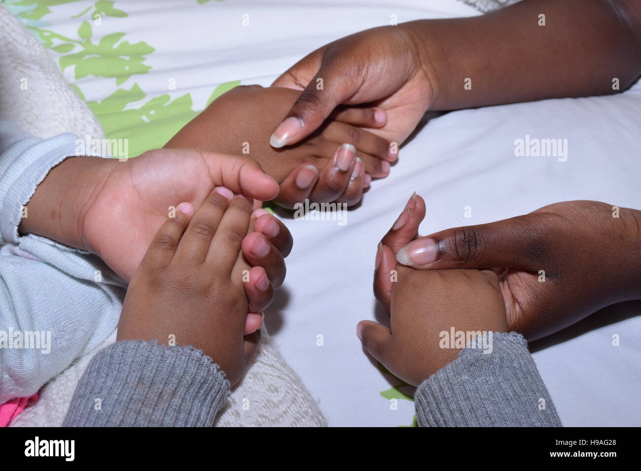Siblings holding hands on a white background Stock Photo - Alamy