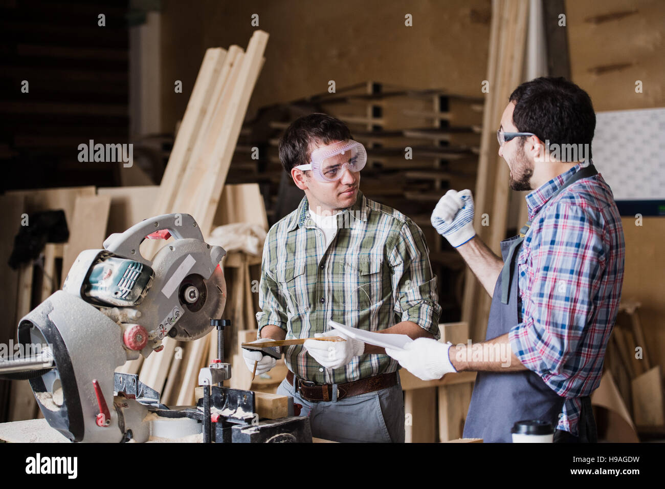 Young constructor sawing wood saw hi-res stock photography and images ...