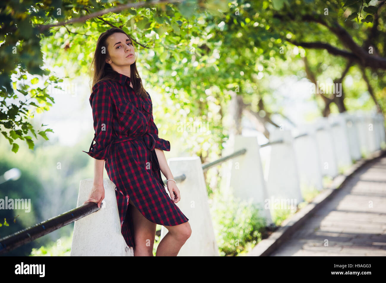 Attractive young woman shows her leg while walking in the park Stock ...
