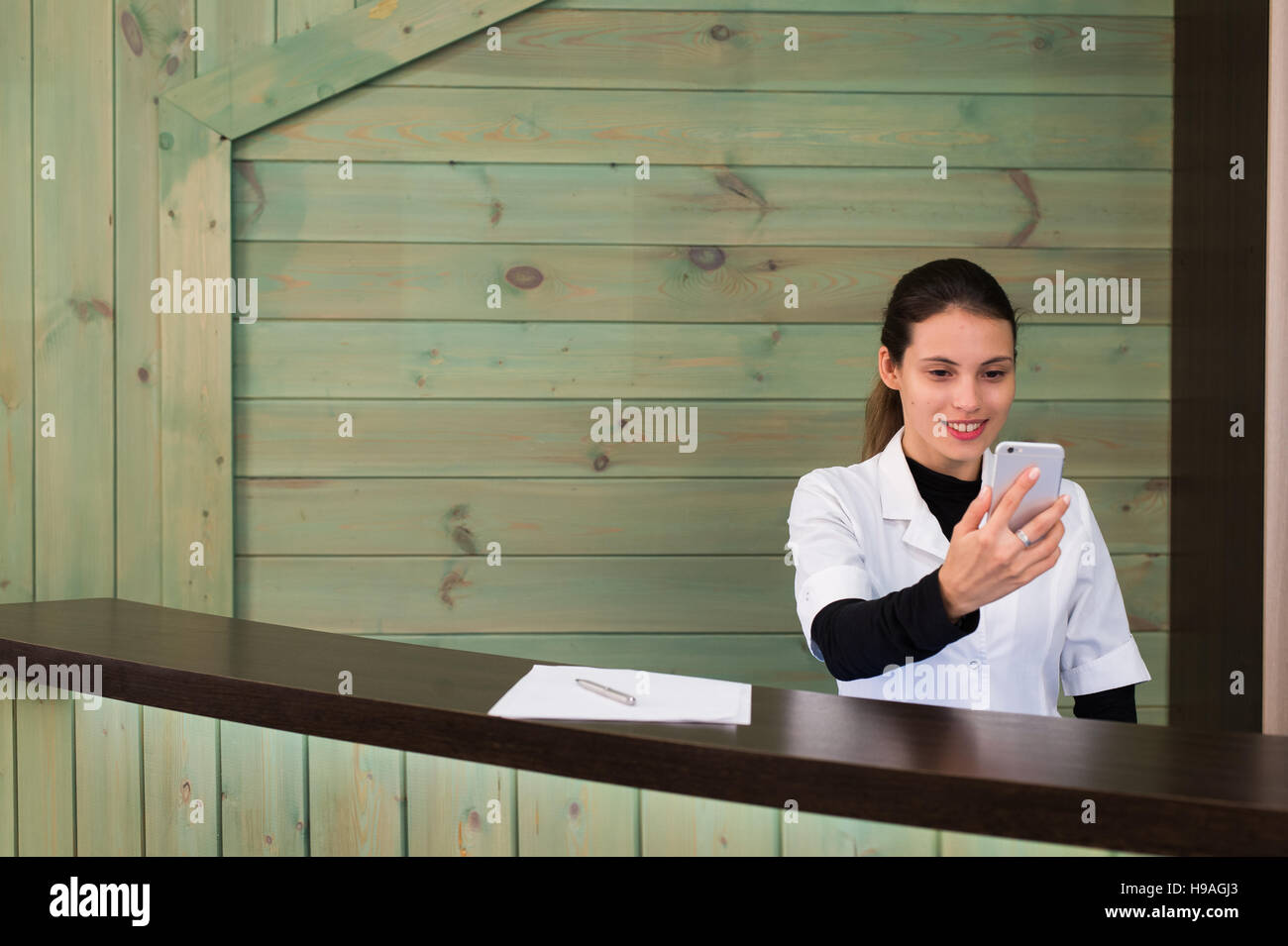 Woman in a spa recpetion uses tablet pc texting to client. Beauty and ...