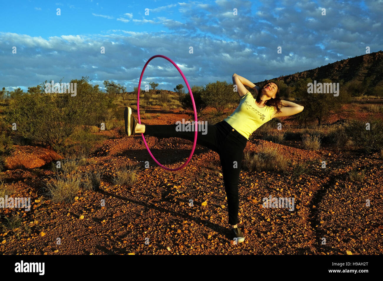 A woman exercises with a hula hoop in Alice Springs, the MacDonnell ...