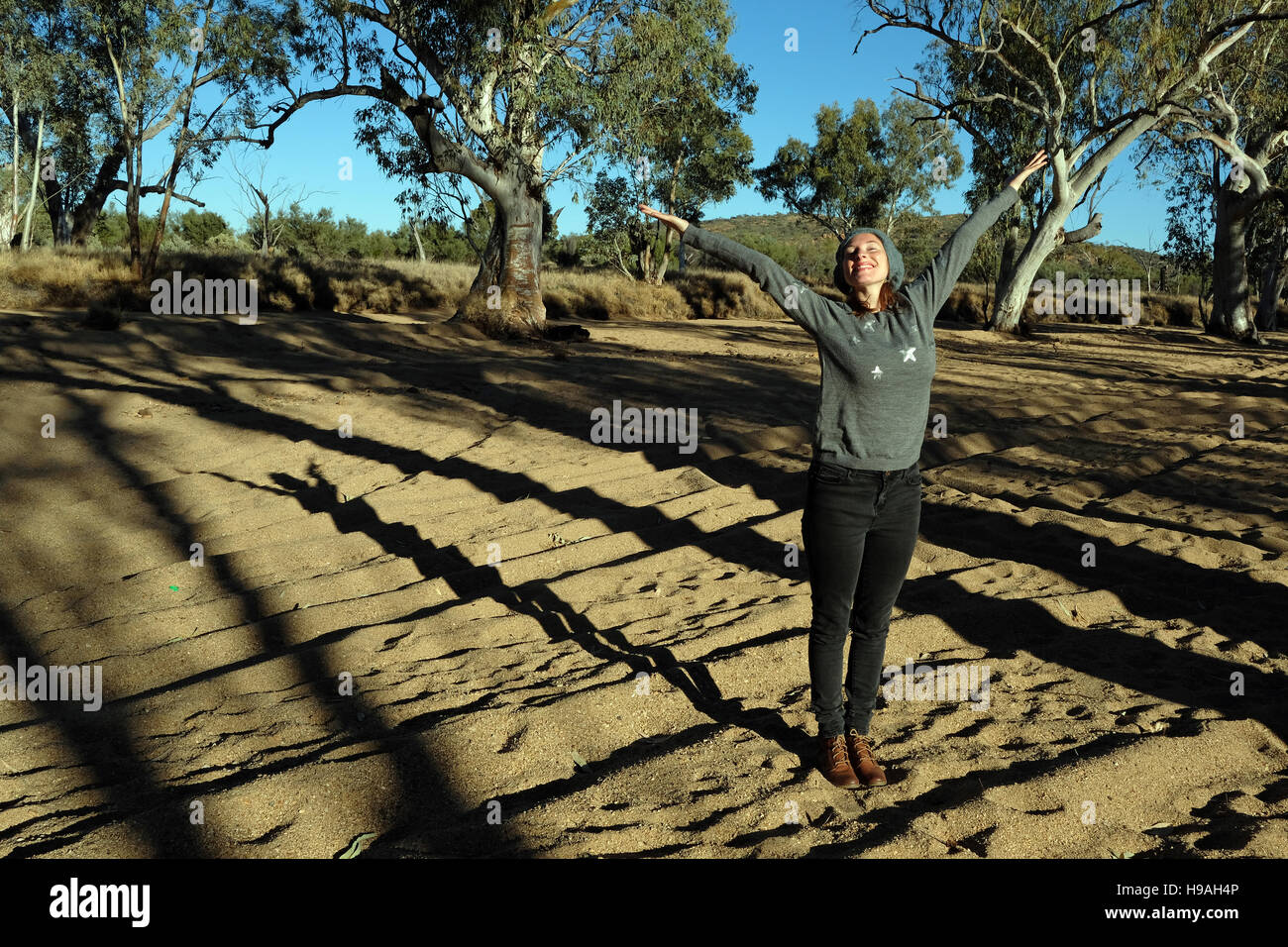 A young woman enjoys the morning sunshine at Roe Creek, Honeymoon Gap ...
