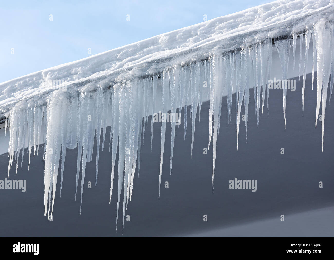 Row of icicles glint in the sun Stock Photo - Alamy