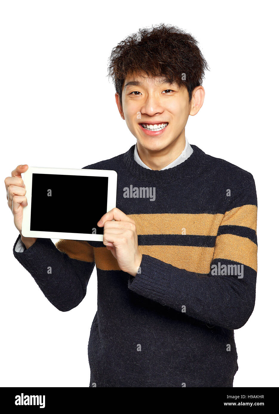 Handsome young Asian man using tablet / pad on white background Stock ...