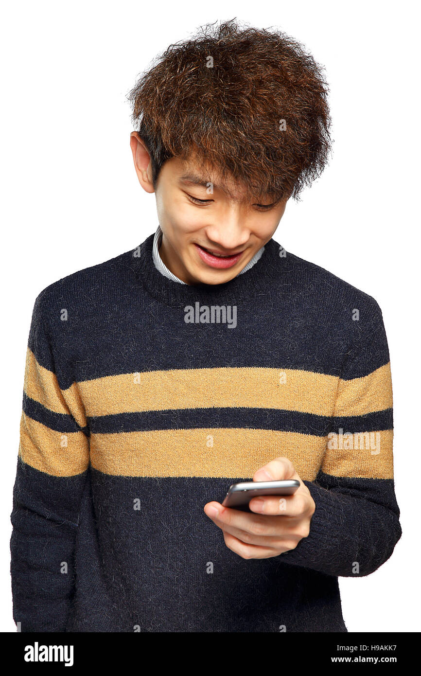 Young man using mobile phone SMS on white background Stock Photo - Alamy