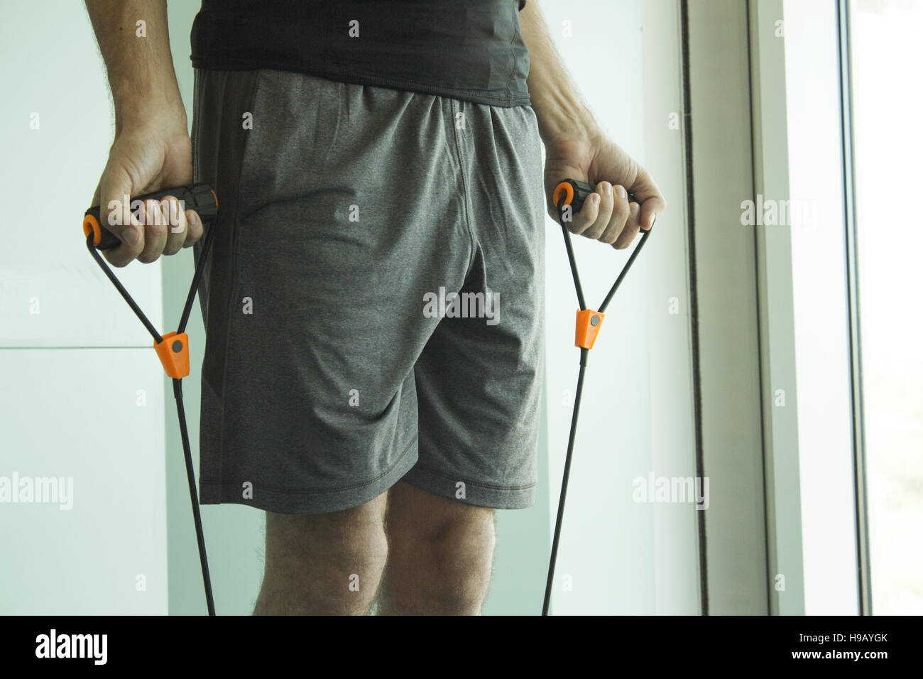 Performing exercises with resistance rope fitness Stock Photo - Alamy