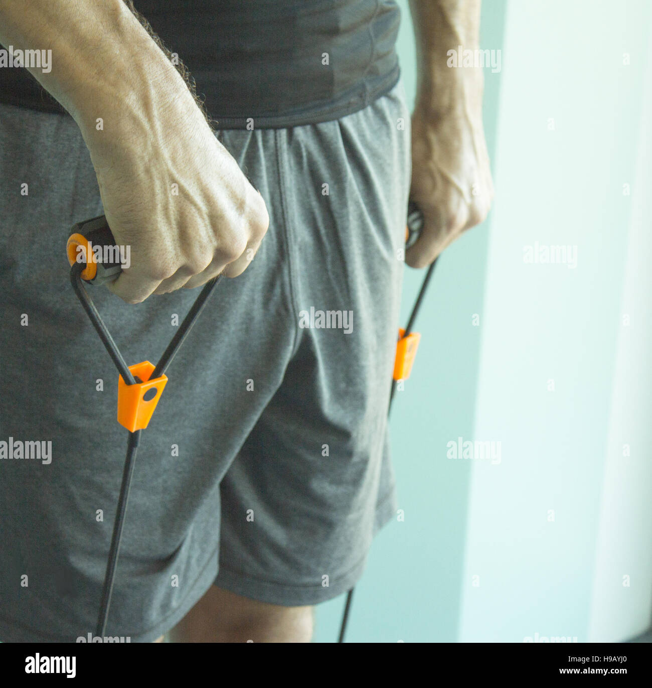 Performing exercises with resistance rope fitness Stock Photo - Alamy