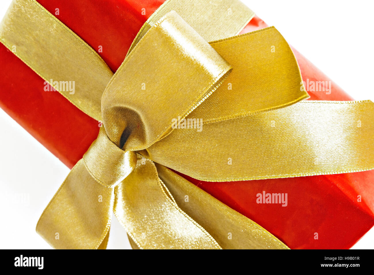 Gift red box with gold ribbon and bow isolated Stock Photo - Alamy