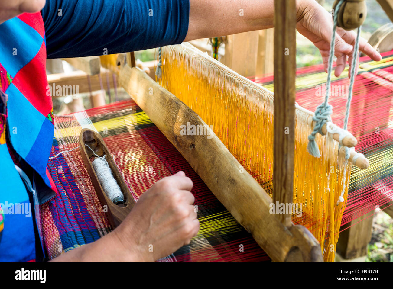 Weaving on a wooden loom Stock Photo - Alamy