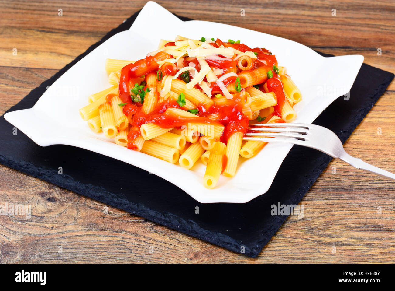 Pasta with Tomato Ketchup Sauce, Green Onions and Cheese Studio Photo ...