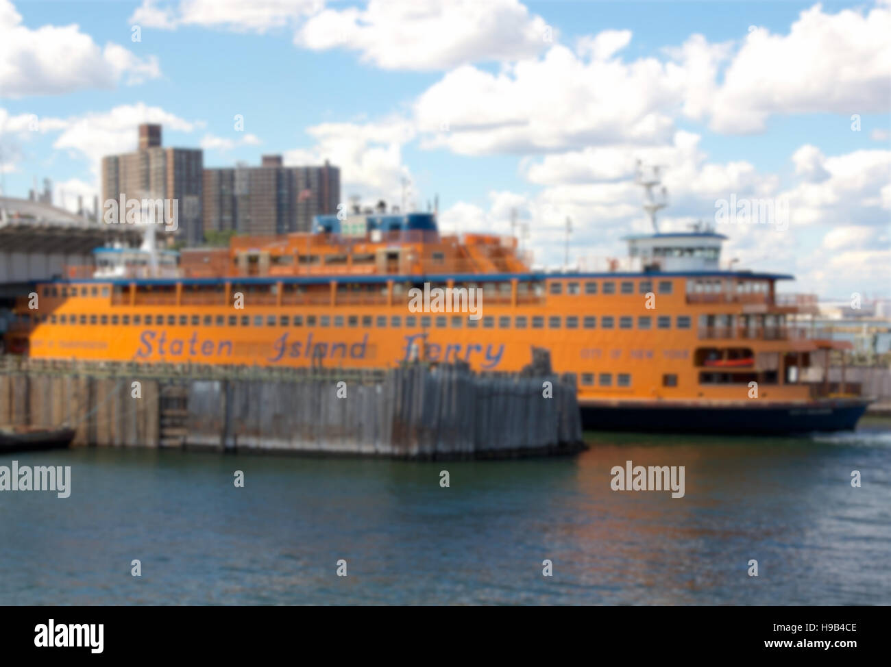 Background blur of St. George's Ferry terminal with a docked Staten ...
