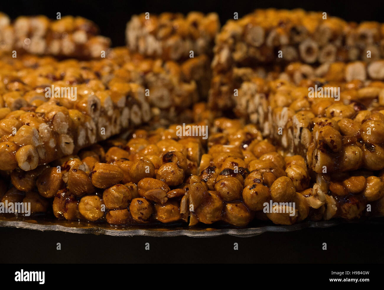Hand made slices of sticky, syrup hazelnut chestnut macadamia nut ...