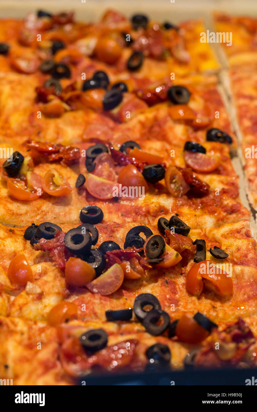 Close up of hand made italian pizza with melted cheese, tomato and ...
