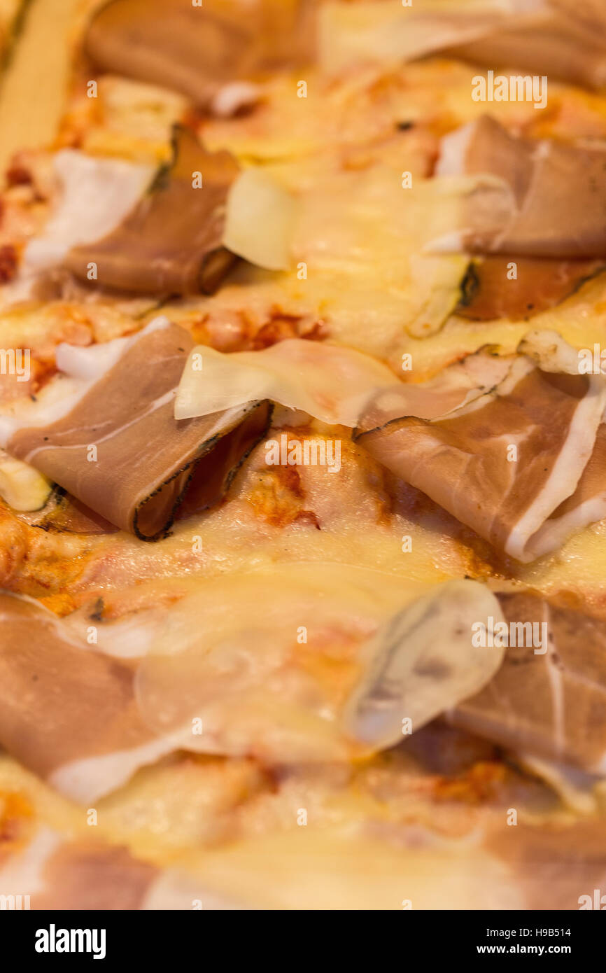 Close up of hand made italian meat feast pizza with melted cheese ...