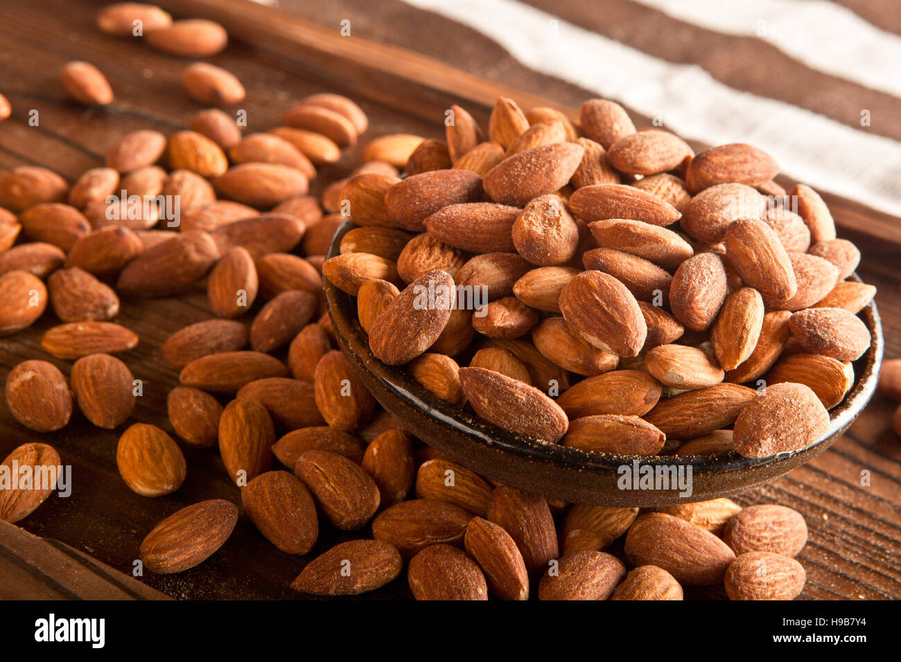 Full bowl of almonds on wooden background Stock Photo - Alamy
