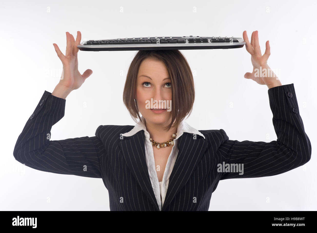 Business woman, 30, with keyboard on her head Stock Photo - Alamy