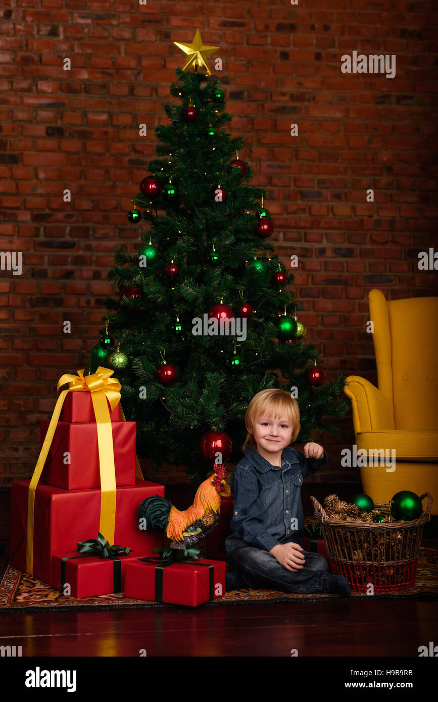 Cute little kid decorating Christmas tree Stock Photo - Alamy