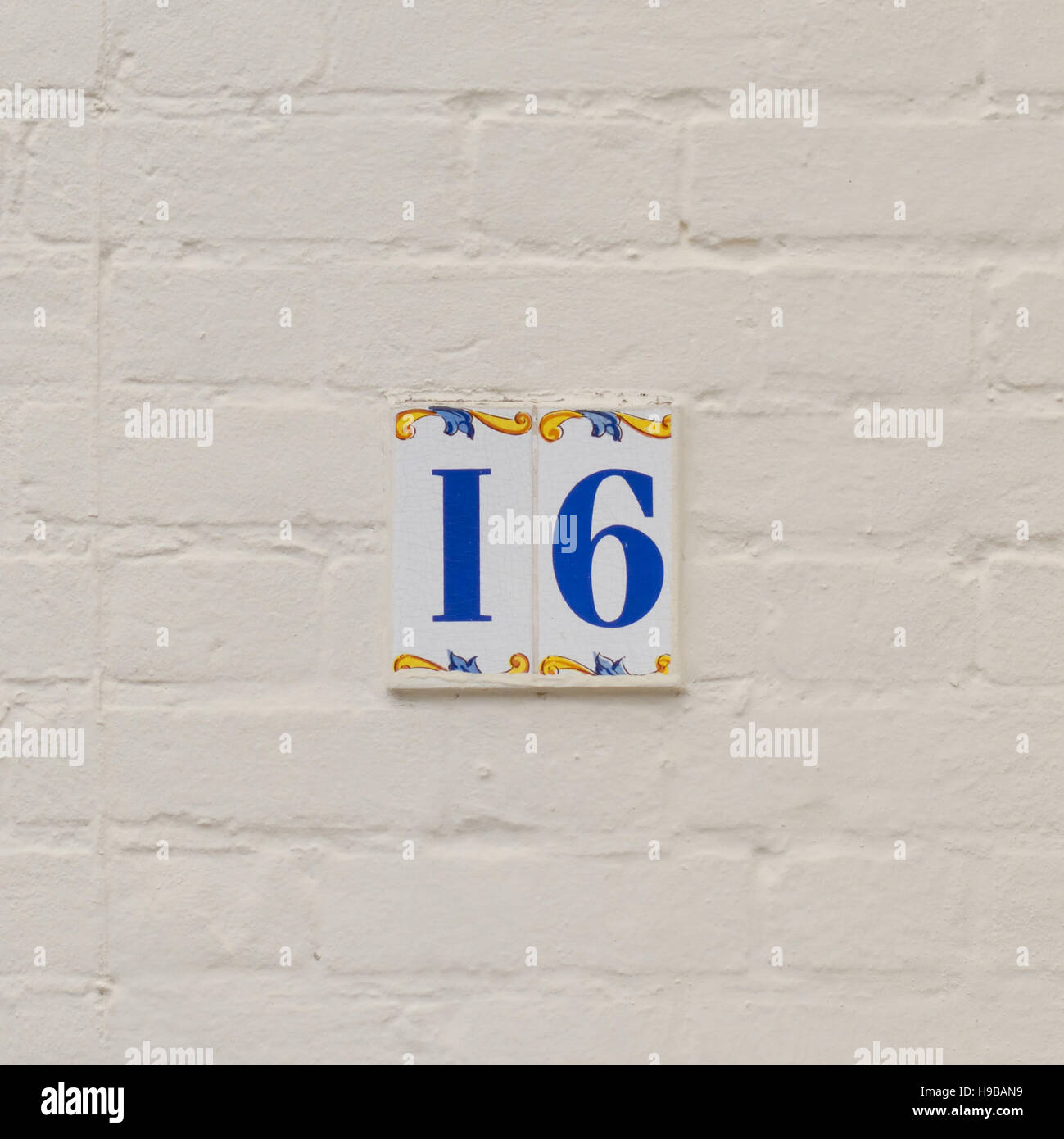 House Number 16 sign on wall Stock Photo - Alamy