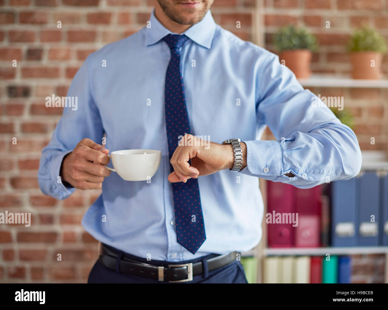 Serious man checking time hand hi-res stock photography and images - Alamy