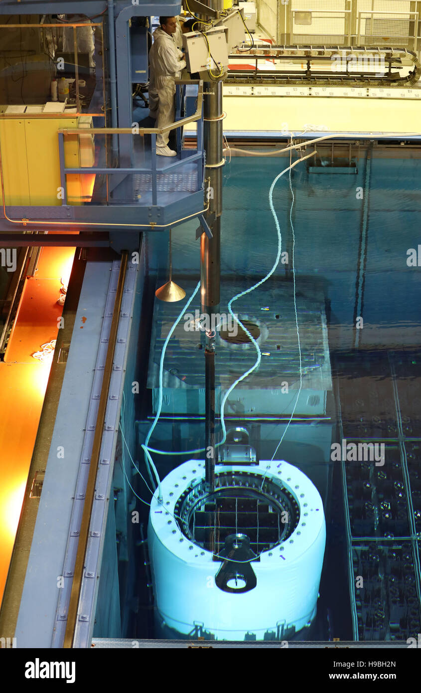 Technicians operate the filling of a castor container with burned off ...