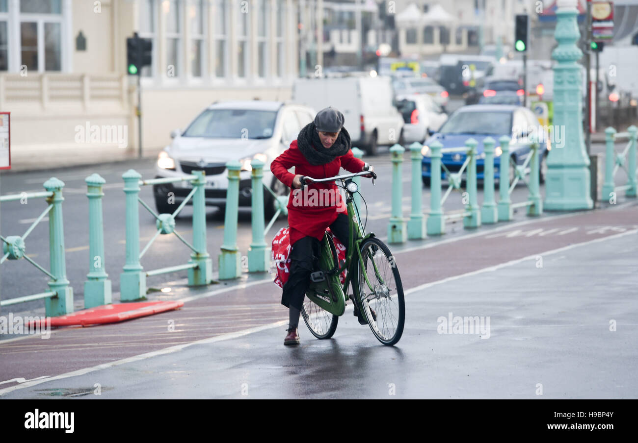 Woman riding her bicycle on wet hi-res stock photography and images - Alamy