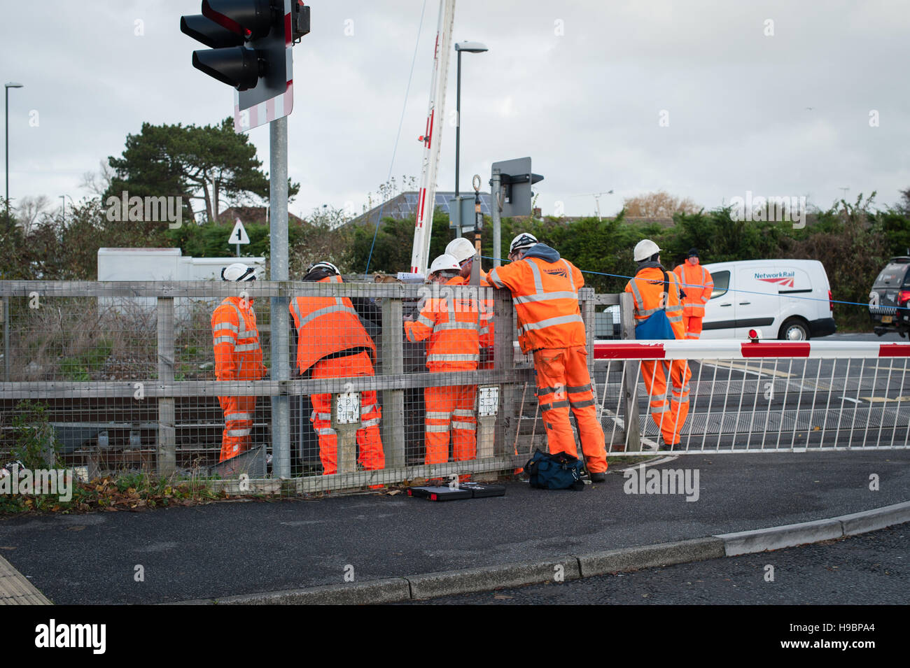 Network Rail engineers repair a railway level crossing barrier after ...