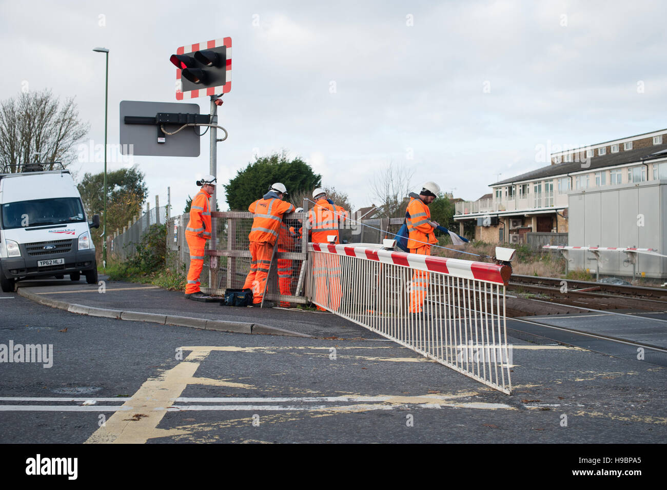 Network Rail engineers repair a railway level crossing barrier after ...
