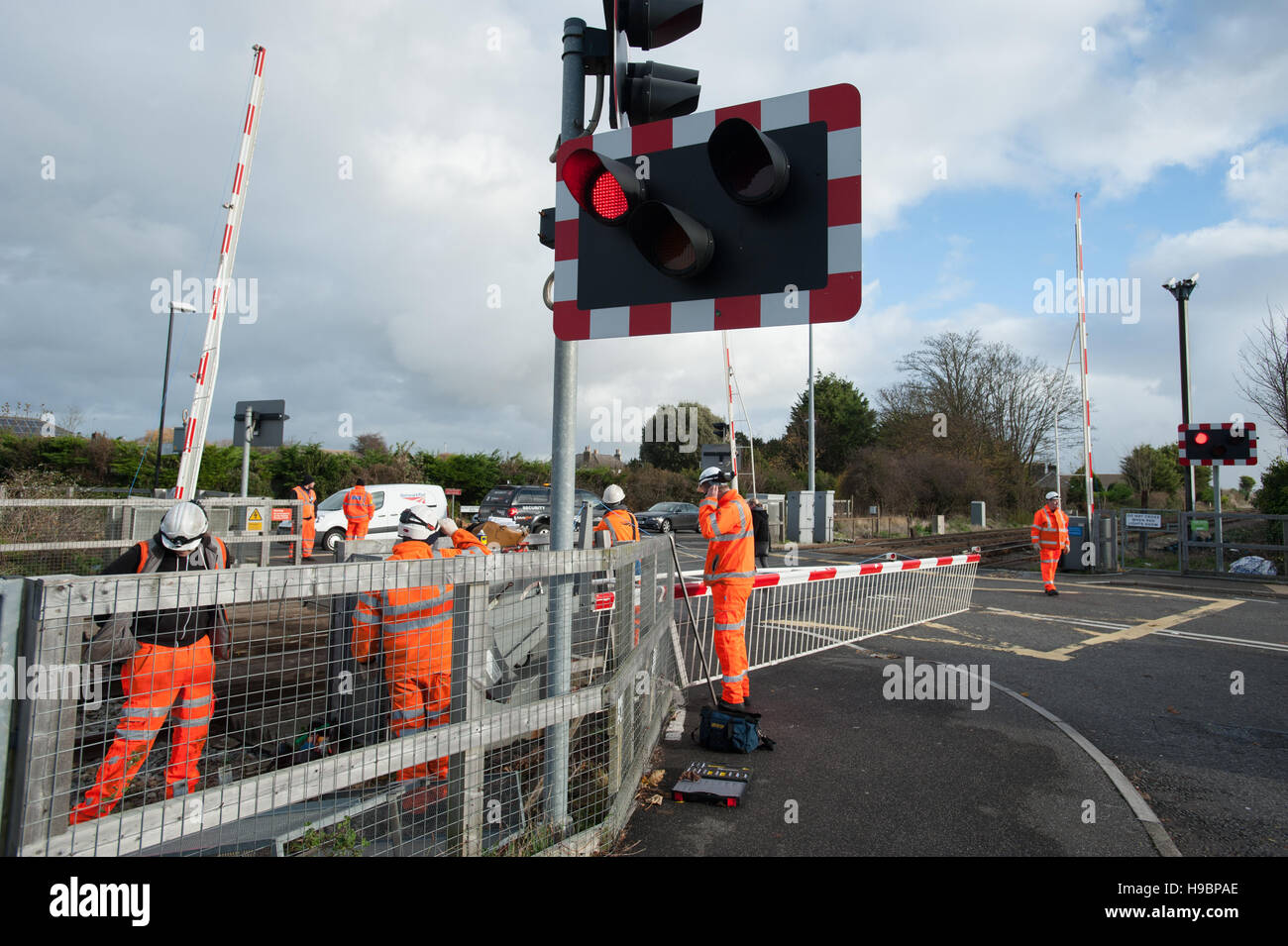 Network Rail engineers repair a railway level crossing barrier after ...