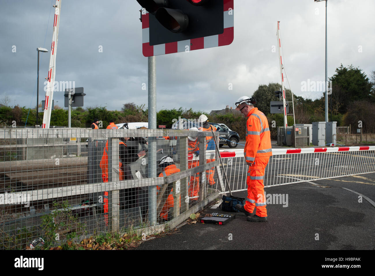 Network Rail engineers repair a railway level crossing barrier after ...