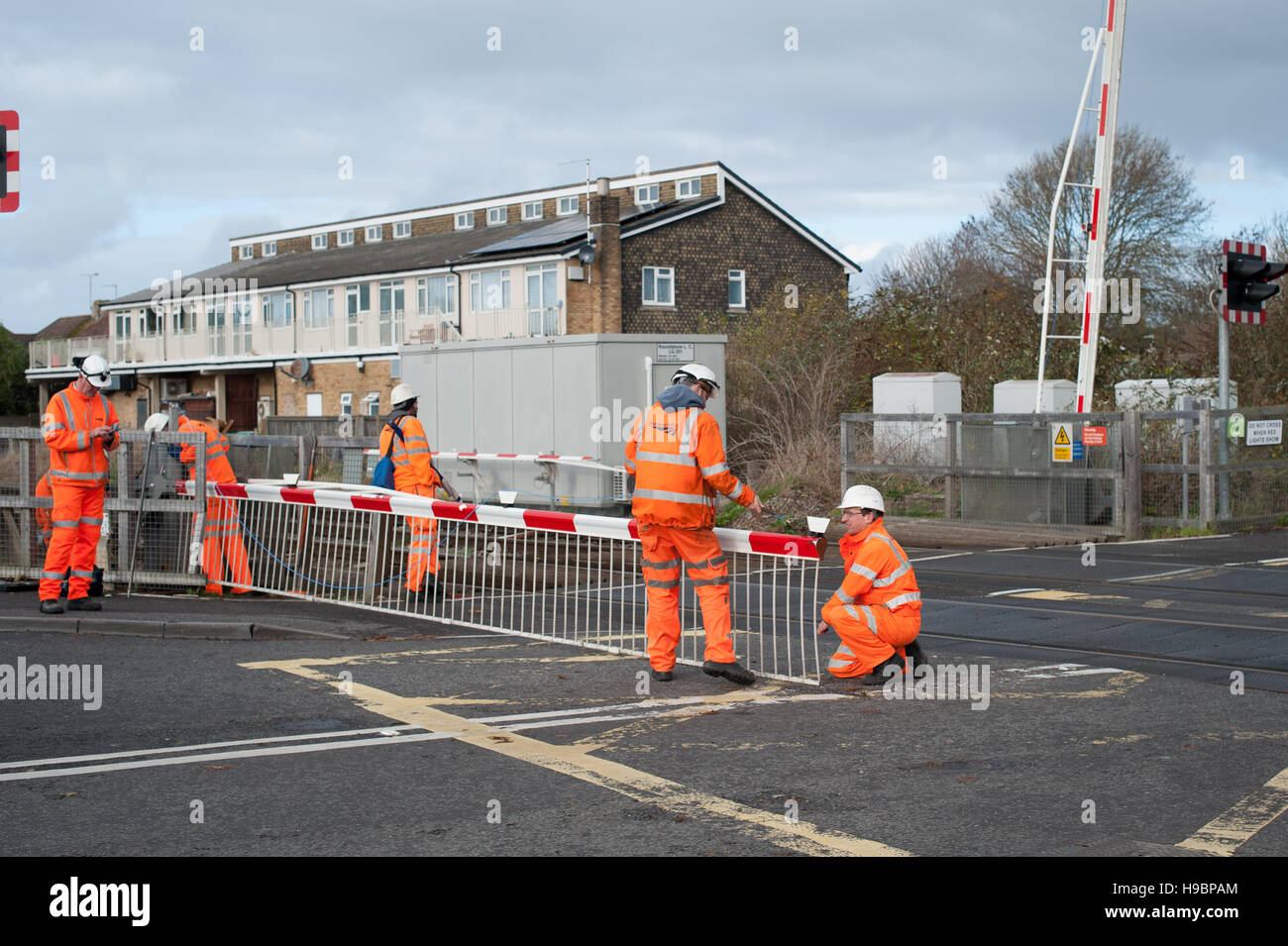 Network Rail engineers repair a railway level crossing barrier after ...