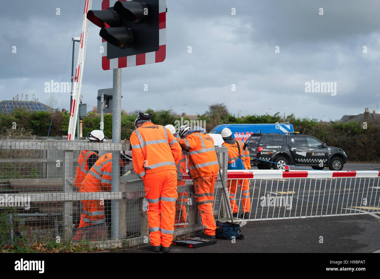 Network Rail engineers repair a railway level crossing barrier after ...