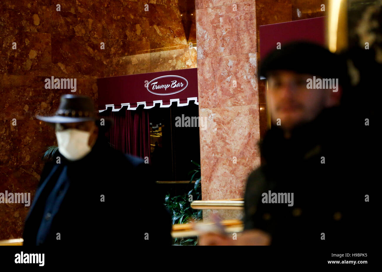 New York, USA. 21st Nov, 2016. Tourists walk past the Trump Bar ...