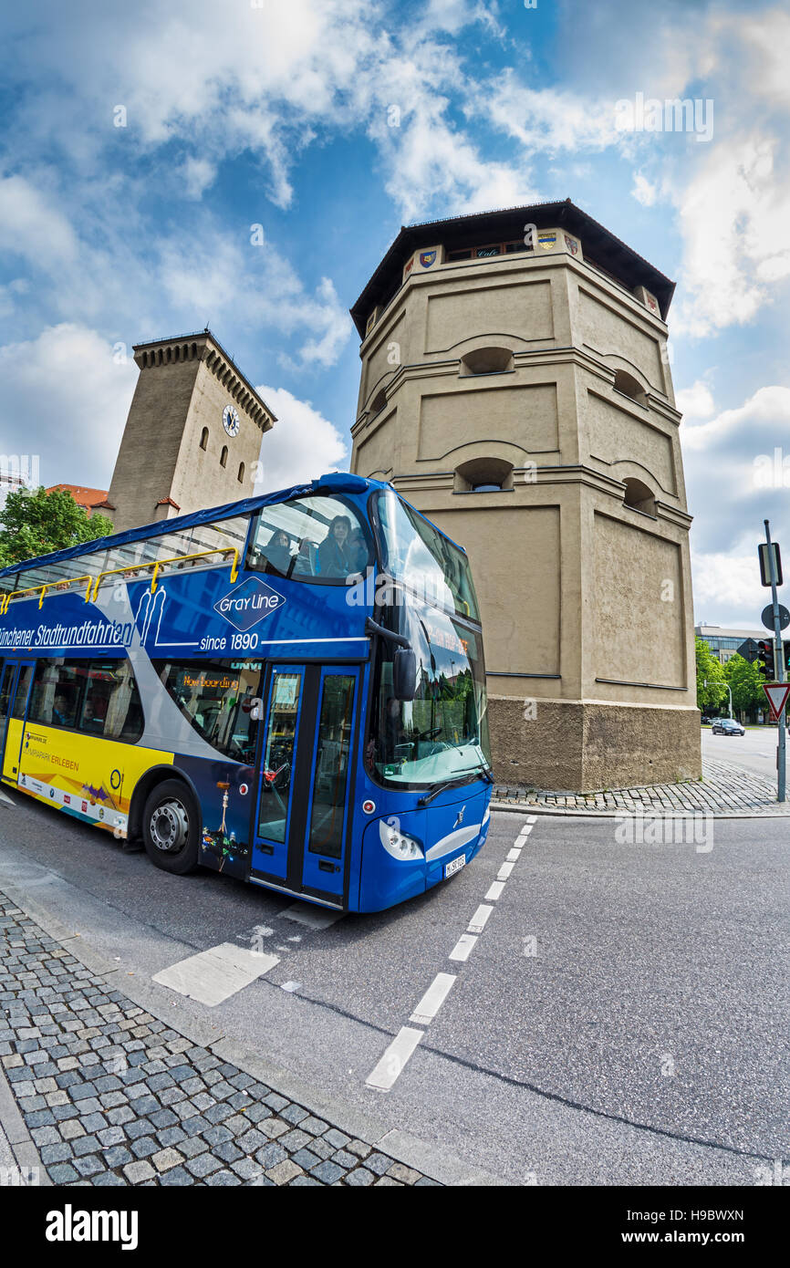 MUNICH, GERMANY - MAY 15, 2016: Tourist bus goes round the Isartor gate ...