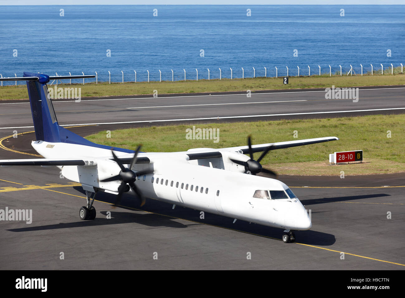 Airplane on the airport runaway near the ocean just arrived Stock Photo ...