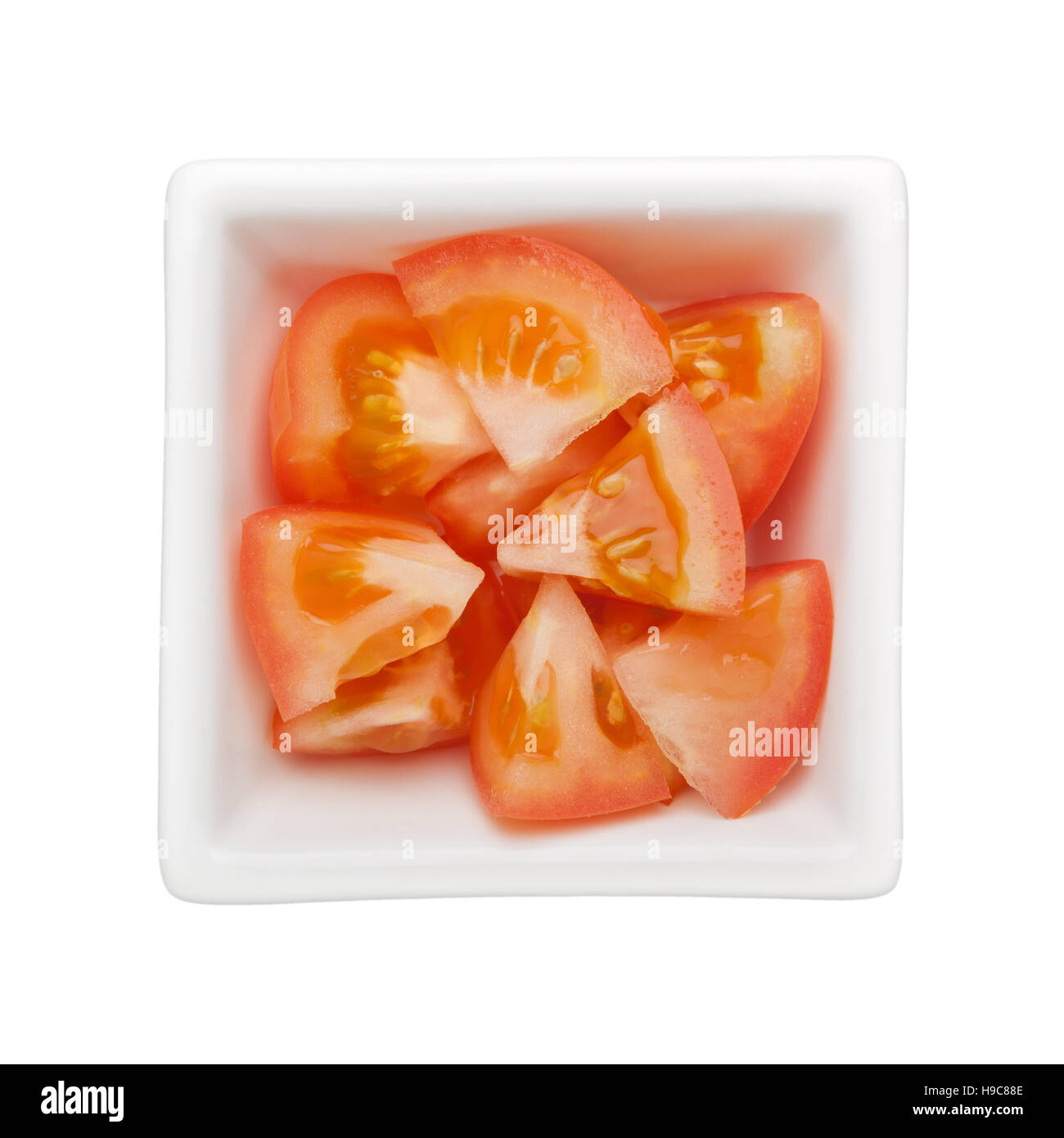 Tomato pieces in a square bowl isolated on white background Stock Photo ...