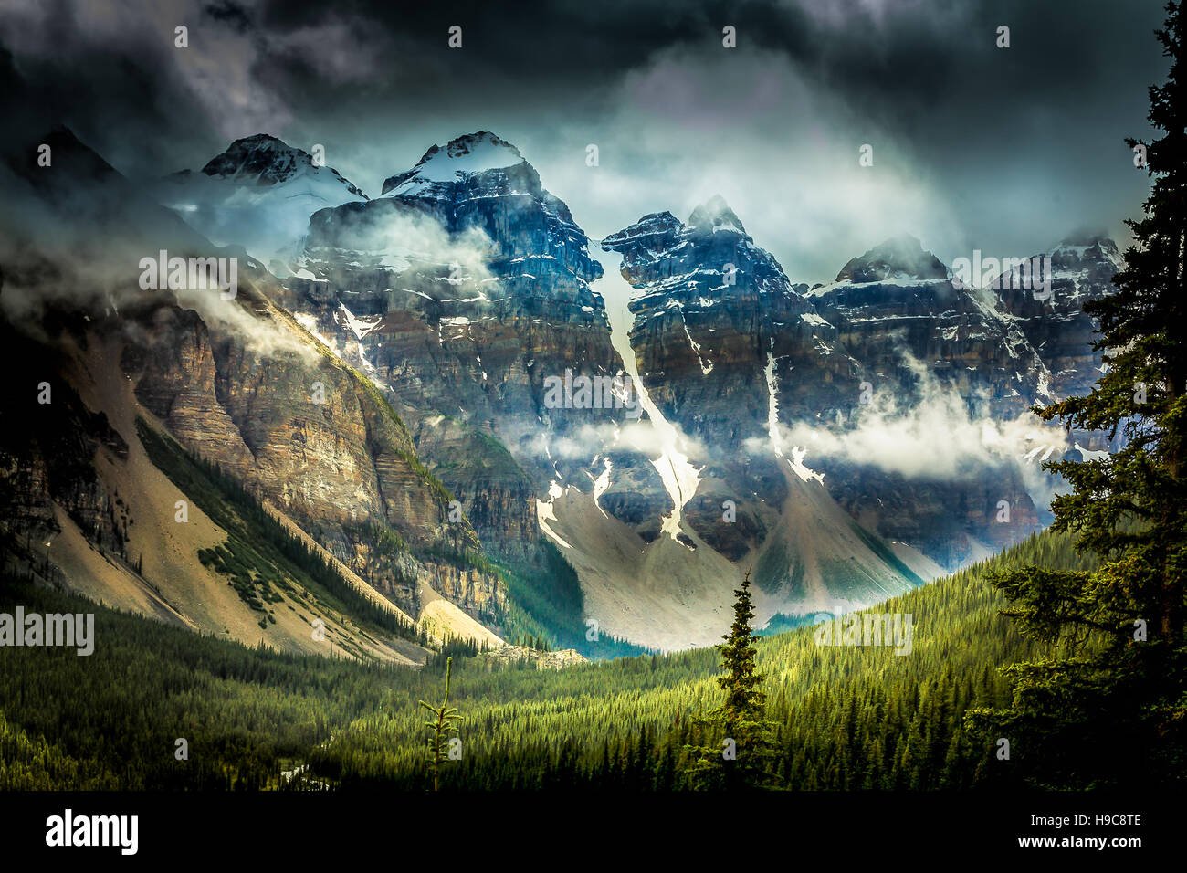 The majestic Canadian Rocky Mountains covered with fog Stock Photo - Alamy