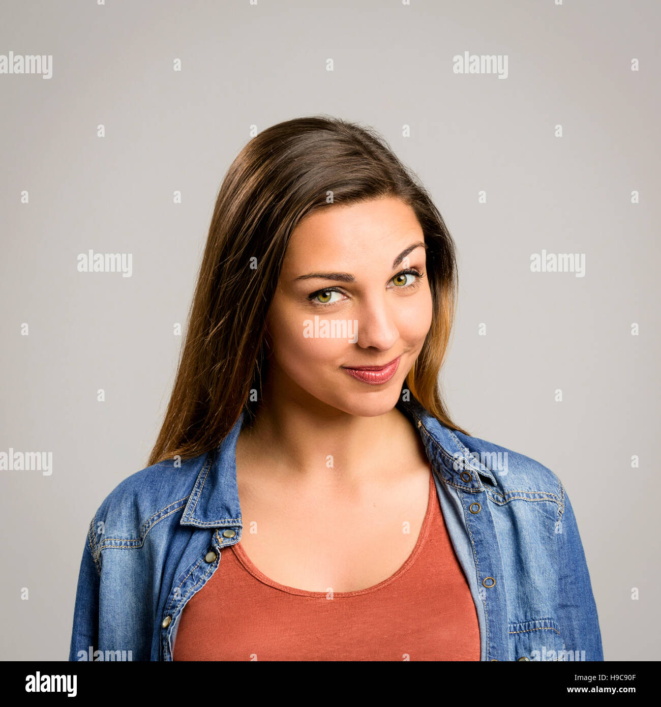 Beautiful young woman making a shy expressions Stock Photo - Alamy