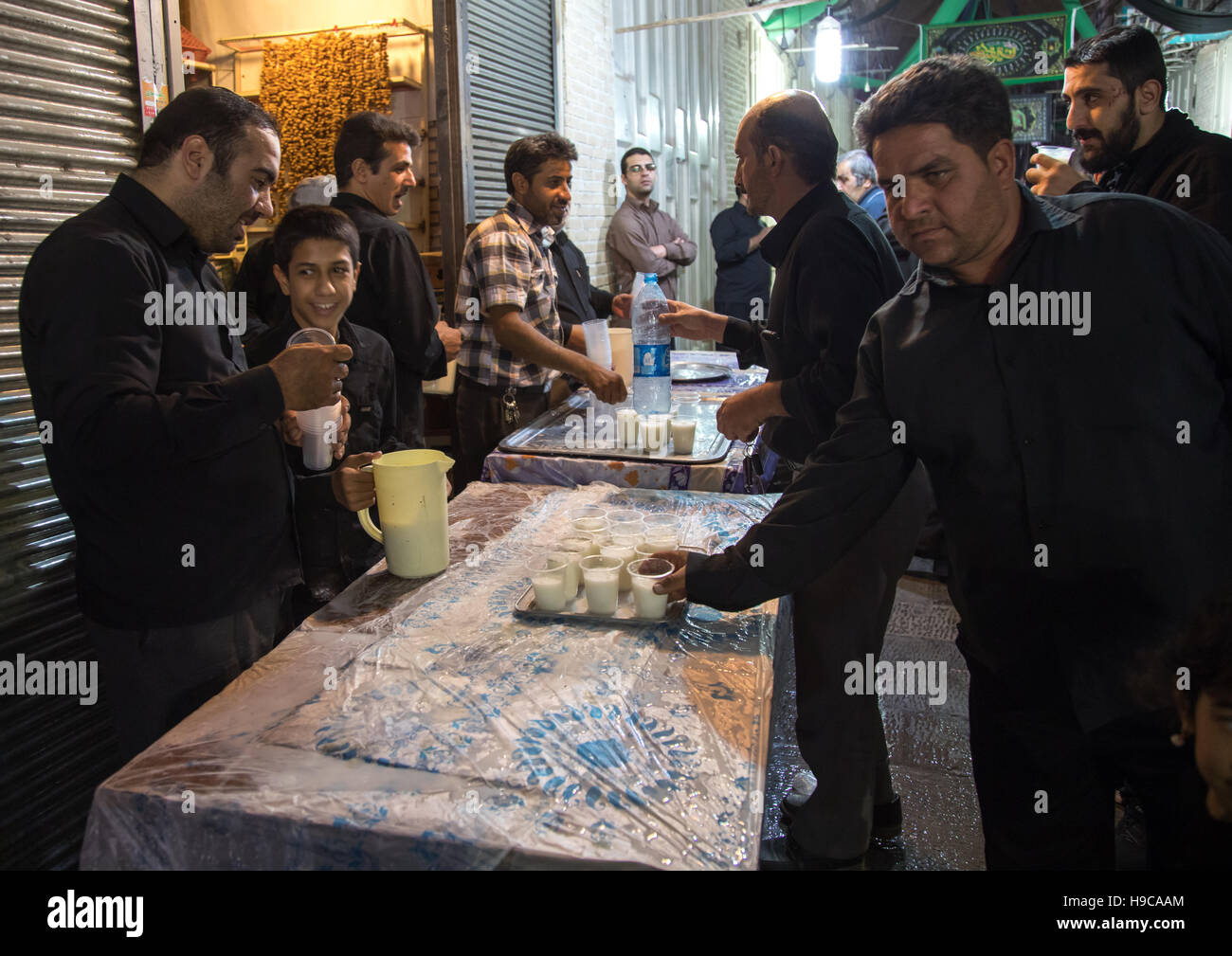 Shiite men offering free milk in the bazaar as nazri during muharram ...