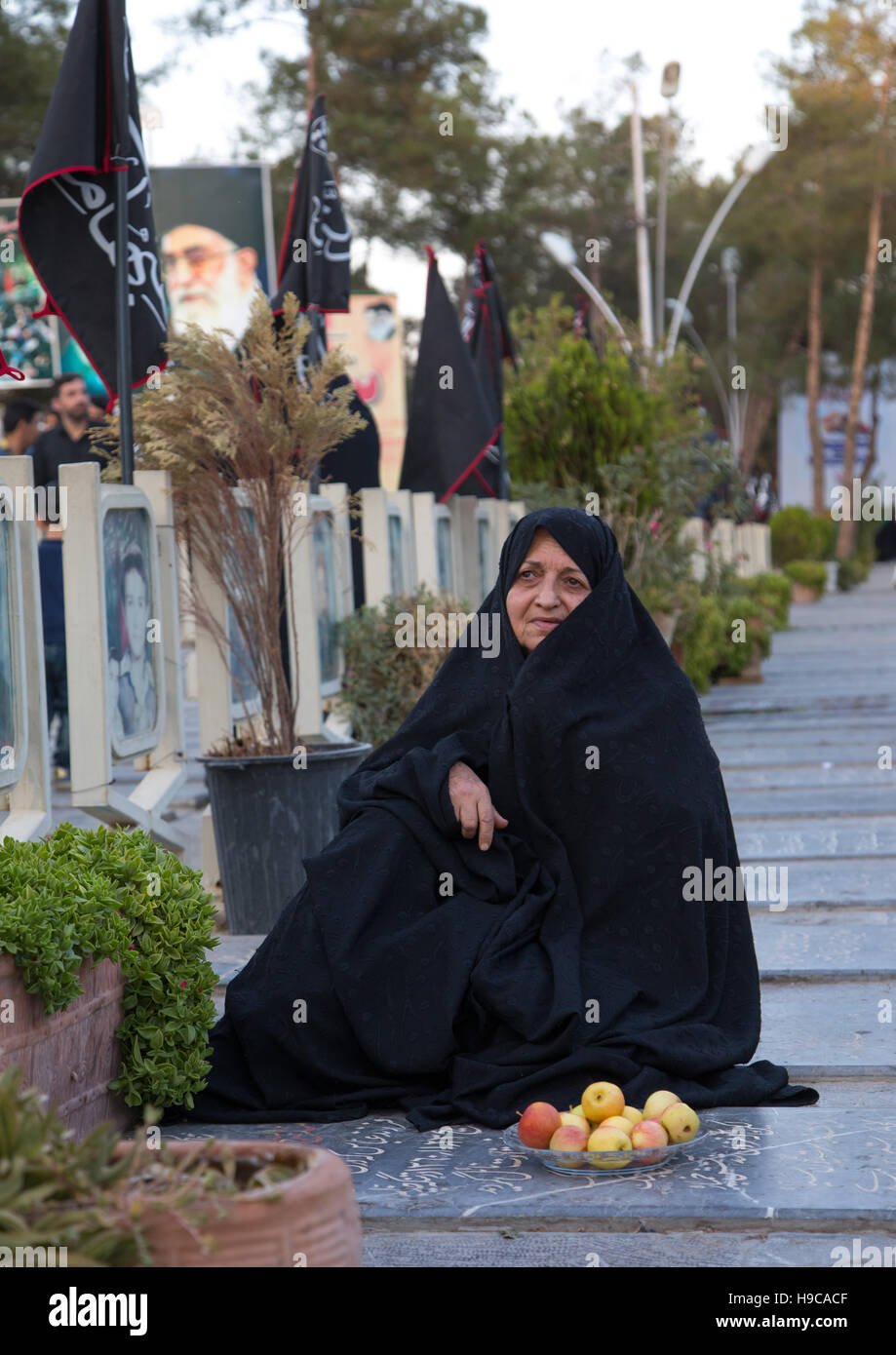 Mother on the tomb of her son killed in the iran iraq war in the rose ...