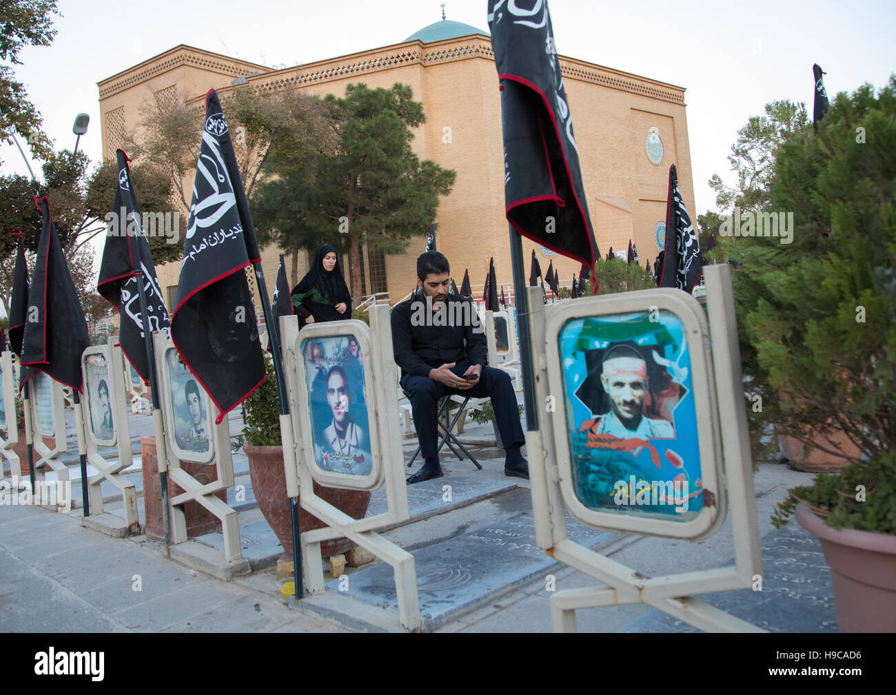 Iranian man praying on the tomb of his relative killed in the iran iraq ...
