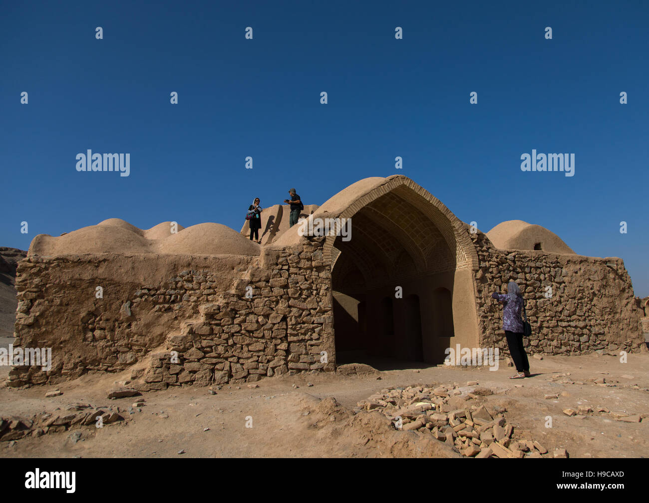 Tourists taking pictures in a zoroastrian old building, Yazd province ...