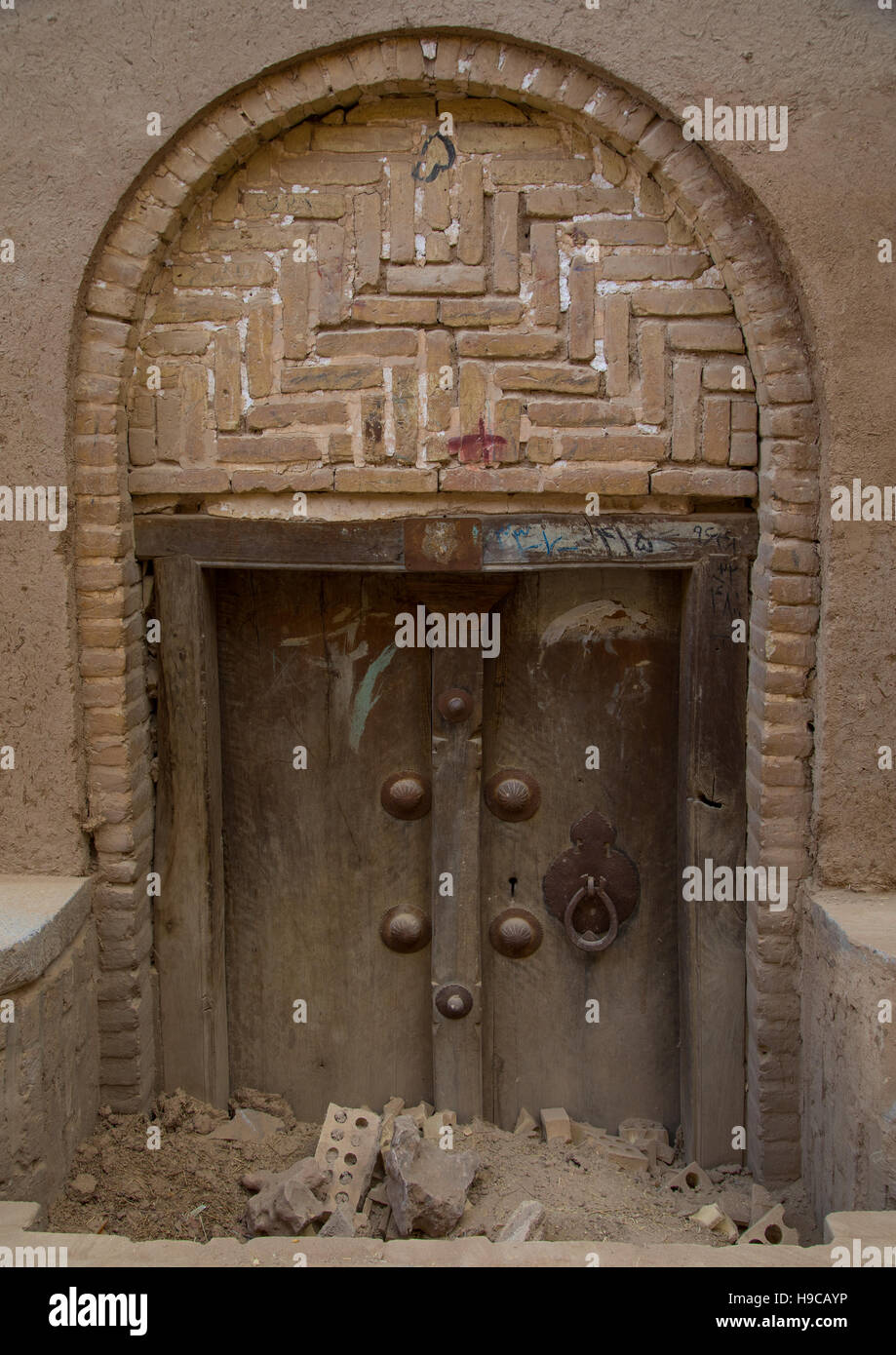 Old wooden door sinking in the ground, Yazd province, Yazd, Iran Stock ...