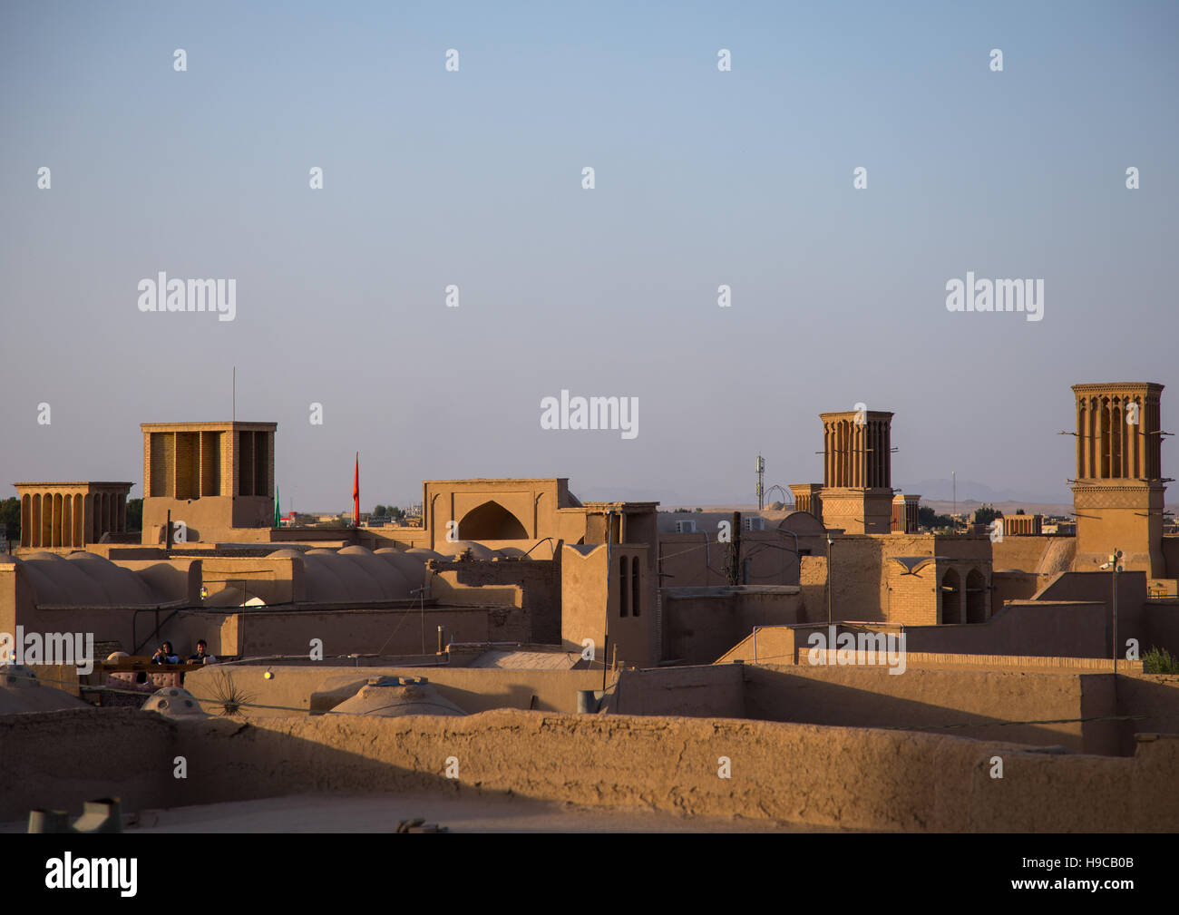 View of the city with traditional wind catchers and mosques at dusk ...