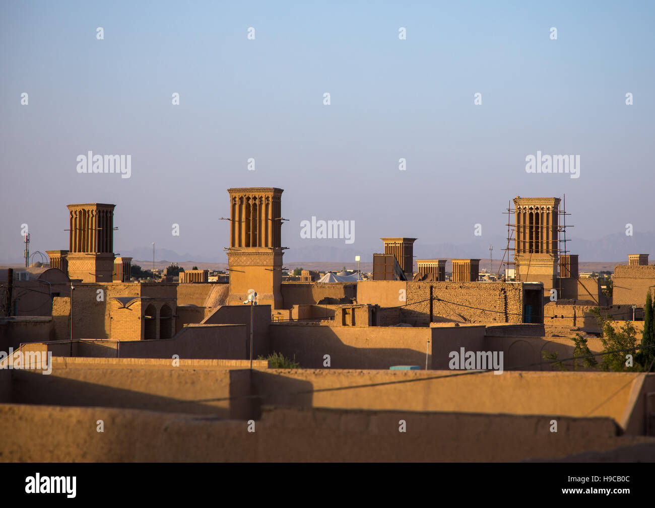 View of the city with traditional wind catchers and mosques at dusk ...