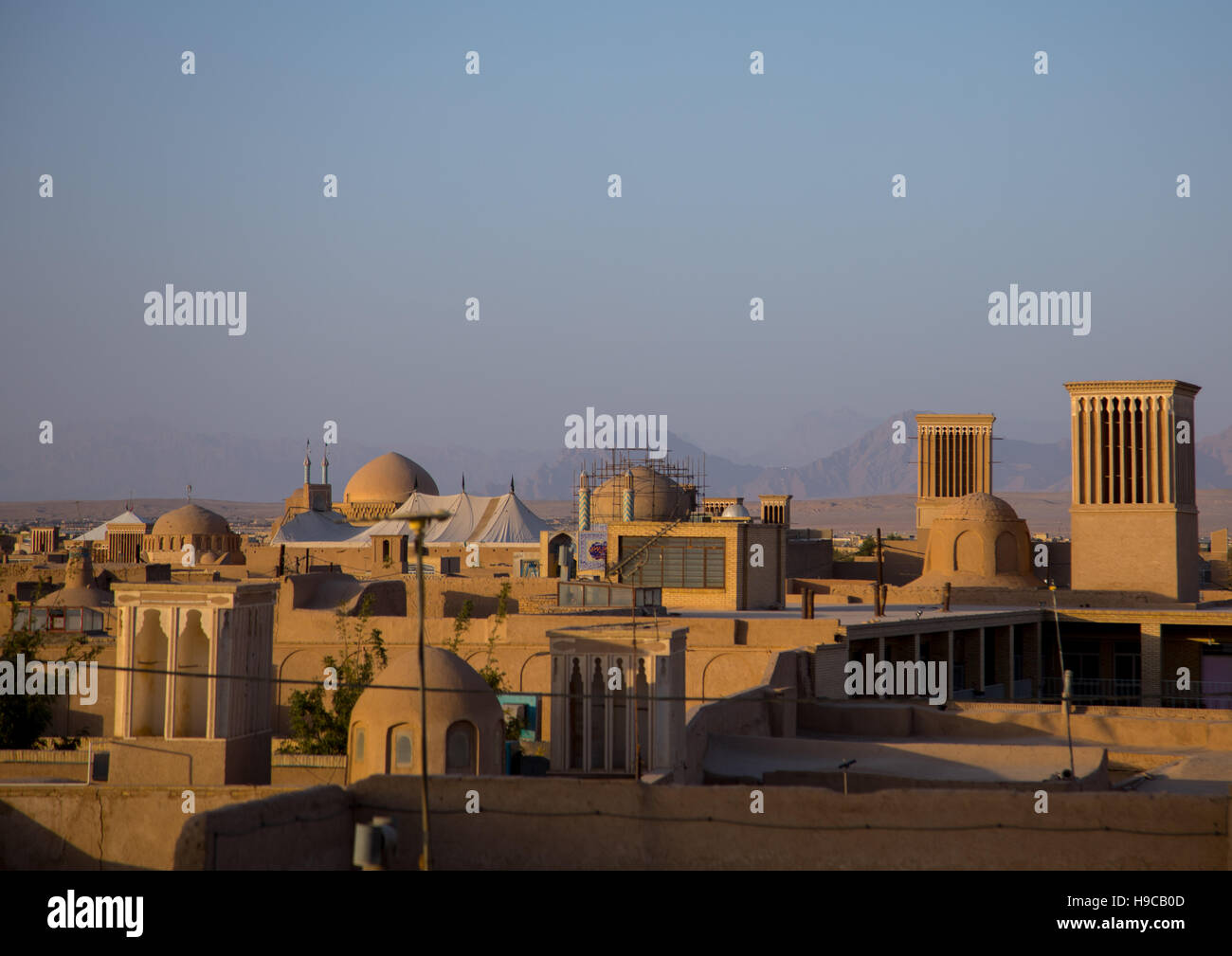 View of the city with traditional wind catchers and mosques at dusk ...