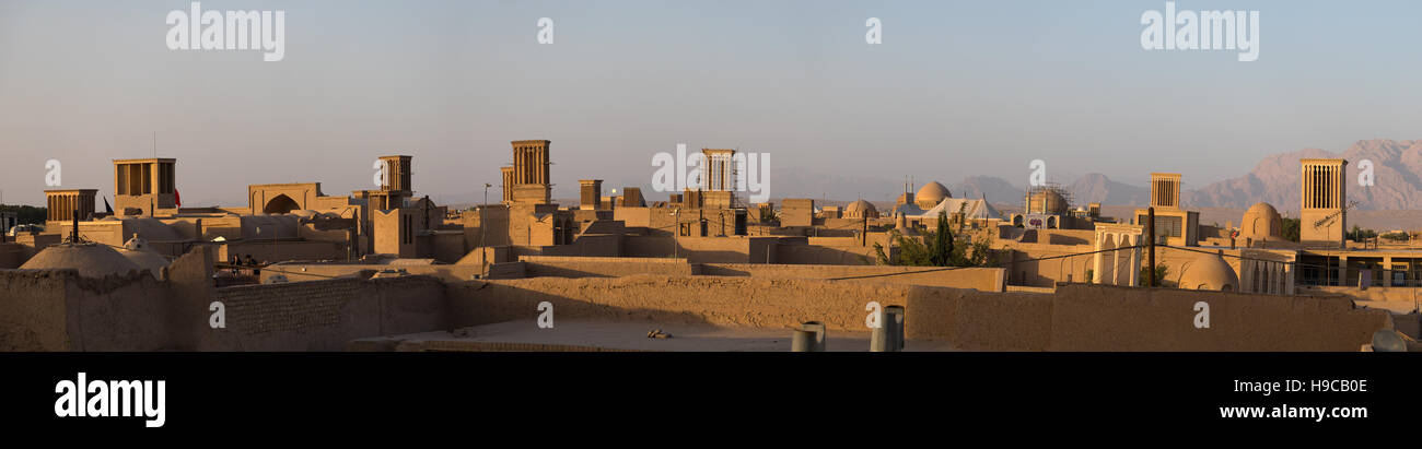 View of the city with traditional wind catchers and mosques at dusk ...