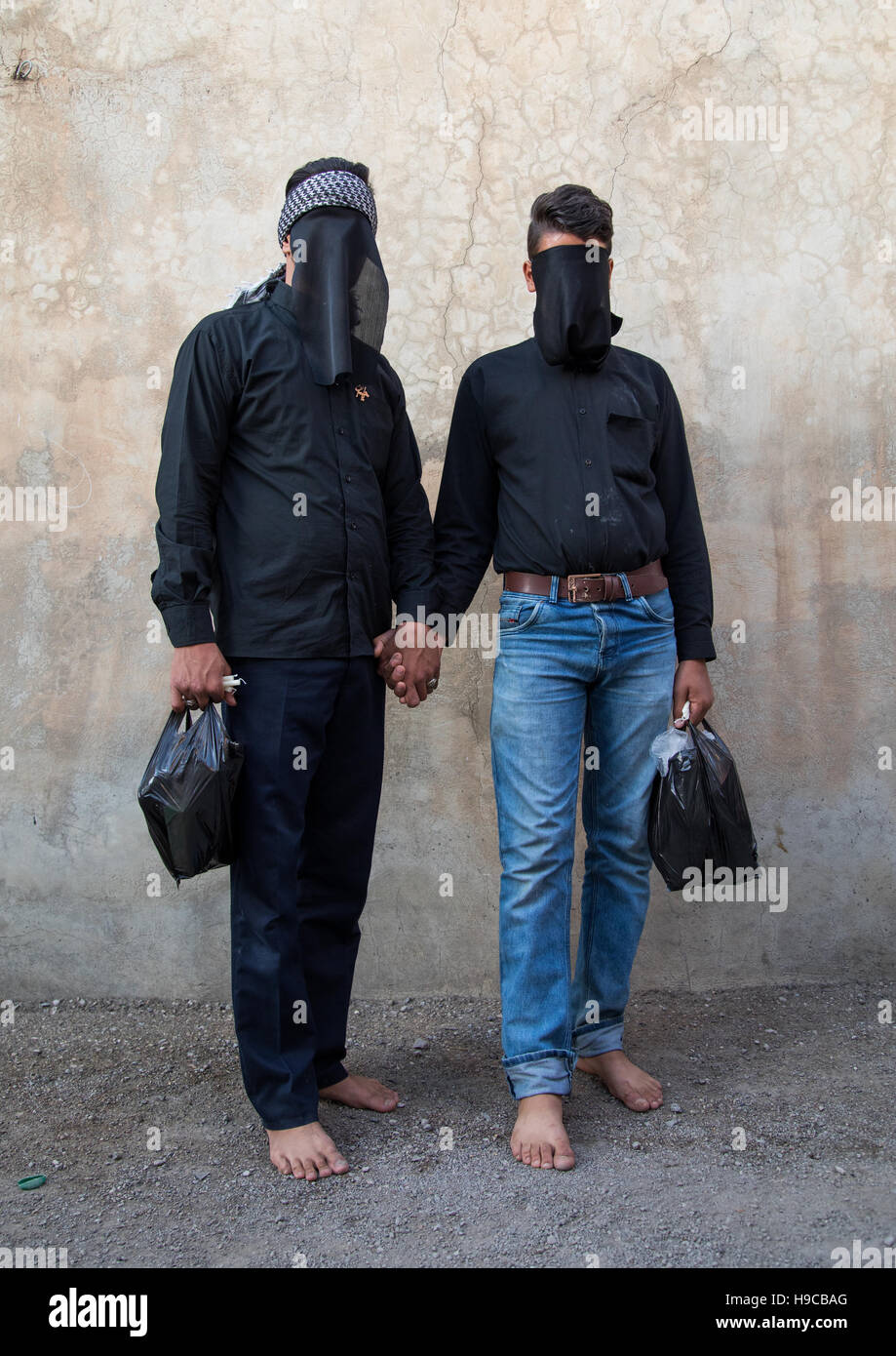 Portrait of iranian shiite muslim men with their faces hidden by a veil ...