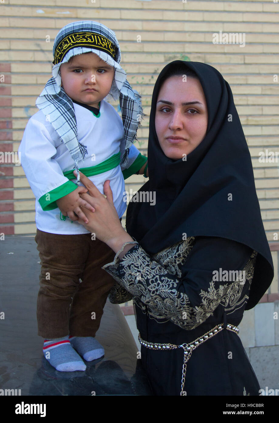 Iranian shiite muslim child dressed for muharram with his mother ...