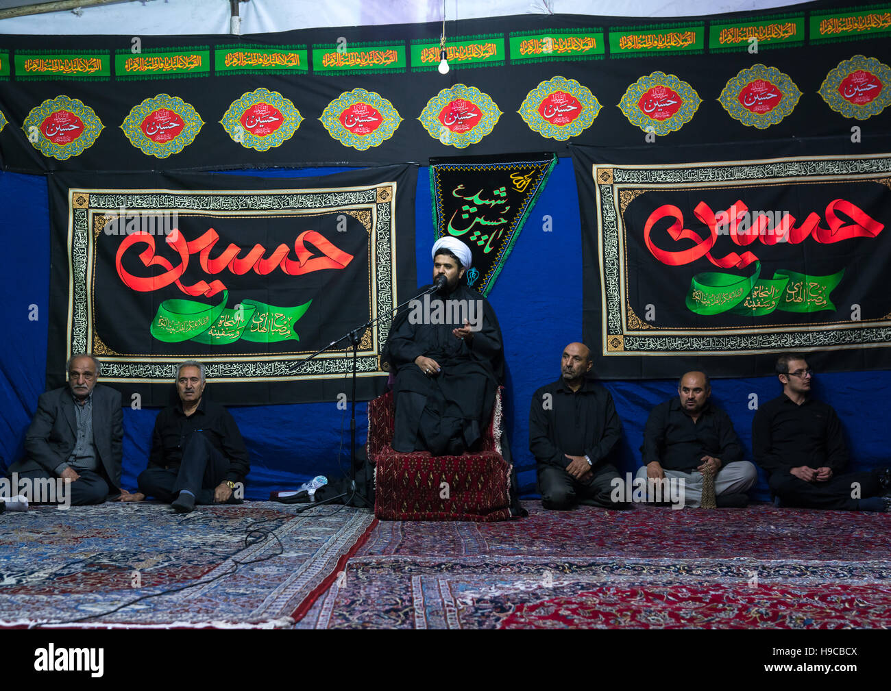 Iranian shiite muslim men listening to a mullah who preaches during ...